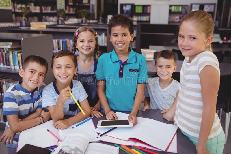 Portrait of Smiling Schoolkid Using Digital Tablet in Library Stock ...