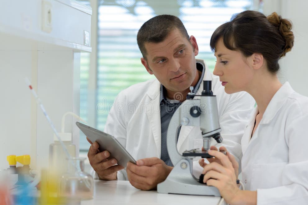Portrait Smiling Scientists Writing in Notepad in Lab Stock Photo ...