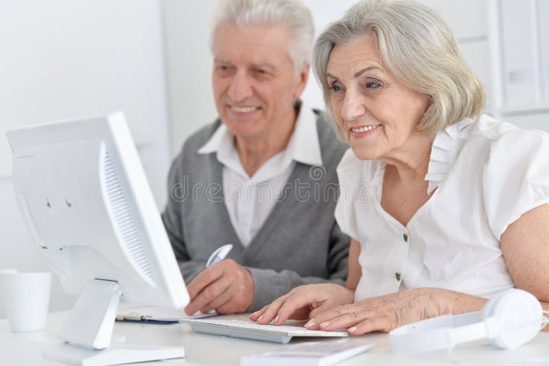 Portrait of Smiling Senior People Working with Computer at Home Stock ...