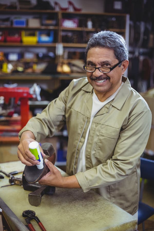 Portrait of Smiling Shoemaker Applying Glue on Shoe Stock Photo - Image ...