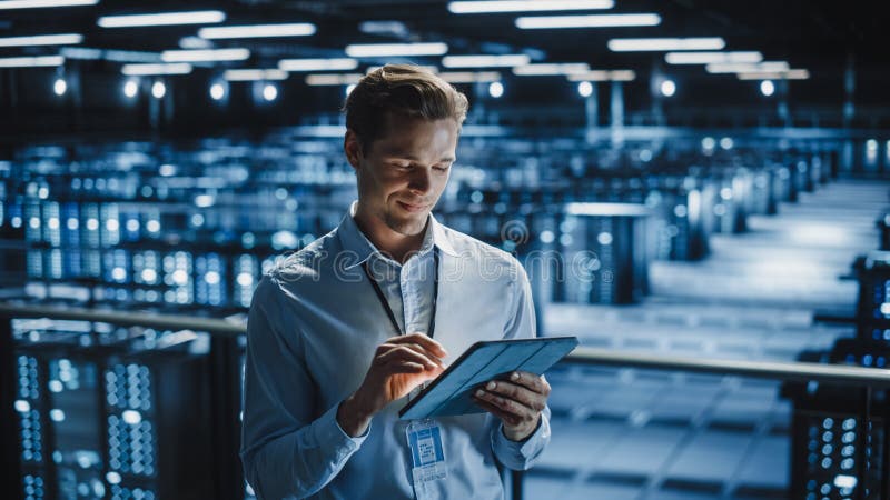Portrait of Smiling it Specialist Using Tablet Computer in Data Center ...