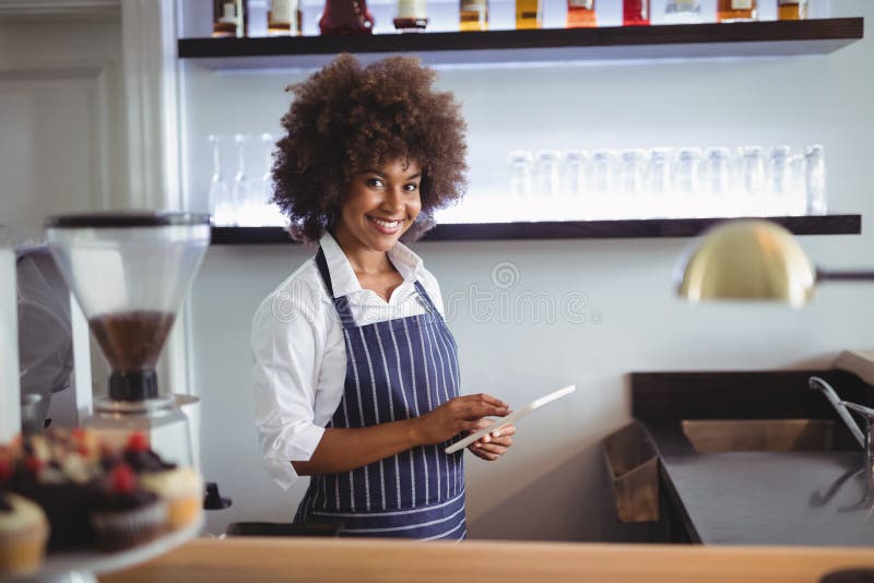 Portrait of Smiling Waitress Using Digital Tablet at Counter Stock ...