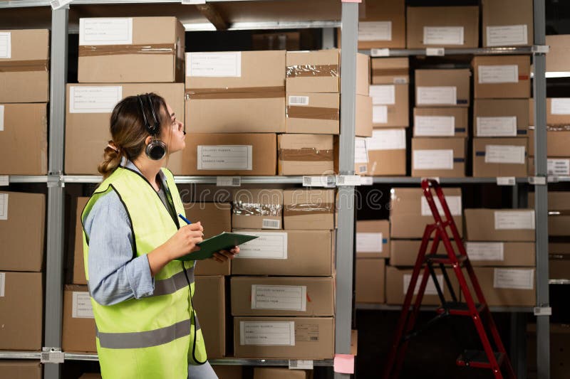 Portrait of a Smiling Warehouse Staff Using a Headset while Working in ...