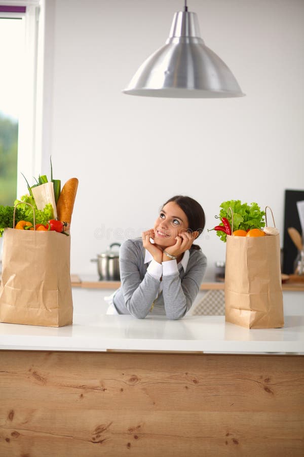 Portrait of a Smiling Woman Cooking in Her Kitchen Sitting Stock Photo ...