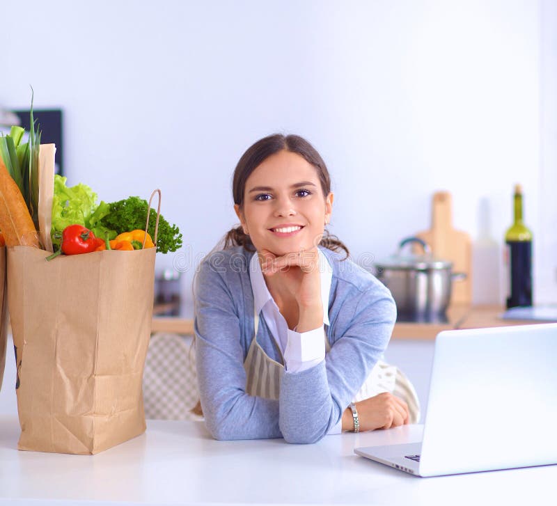 Portrait of a Smiling Woman Cooking in Her Kitchen Sitting Stock Image ...