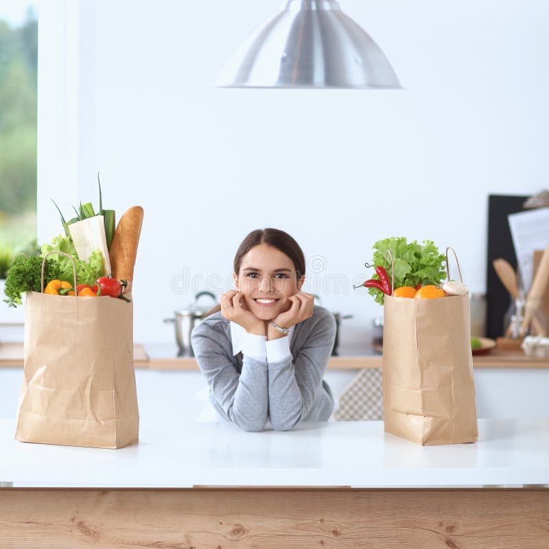 Portrait of a Smiling Woman Cooking in Her Kitchen Sitting Stock Image ...