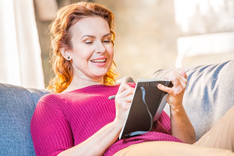 Portrait of Smiling Woman Making Notes Stock Image - Image of working ...