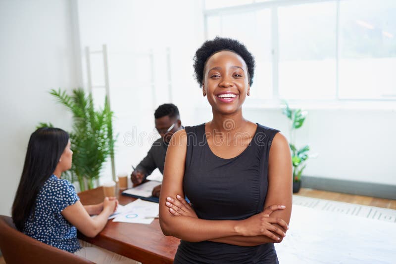 Portrait of a Smiling Young Black Business Woman Arms Folded in ... Portrait of a Smiling Young Black Business Woman Arms Folded in ...