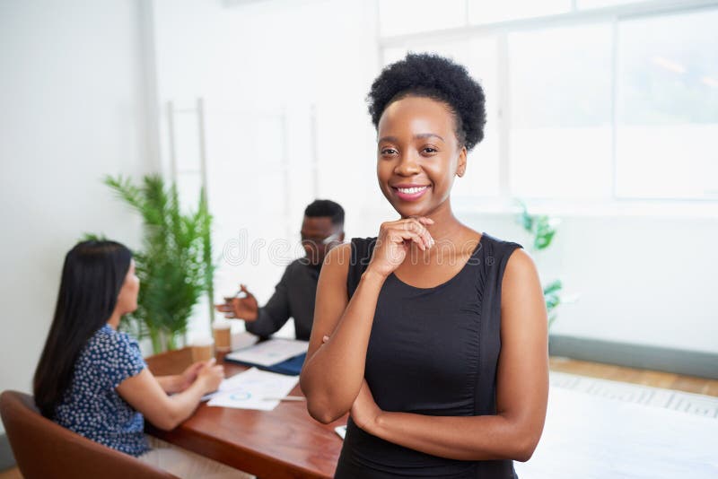 Portrait of a Smiling Young Black Business Woman in Office Boardroom ... Portrait of a Smiling Young Black Business Woman in Office Boardroom ...