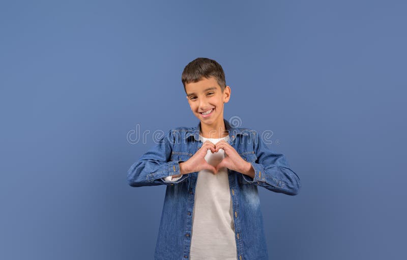 Portrait of Smiling Young Boy Making Heart Shape with Hands while ...