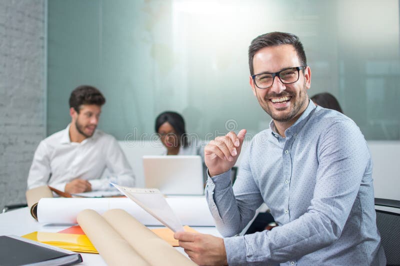 Portrait of Smiling Young Businessman Holding Paper Document and ...