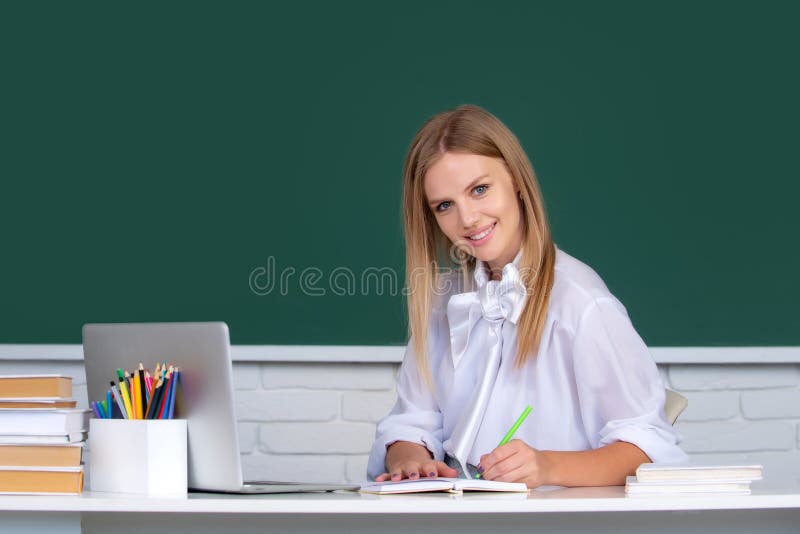 Portrait of Smiling Young College Student Writing on Notebook, Studying ...