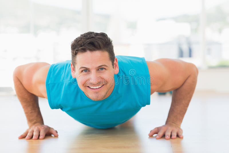 Portrait of a Smiling Young Man Doing Push Ups Stock Image - Image of ...