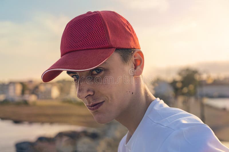Smiling Young Man with Red Baseball Cap Stock Image - Image of smiling ...