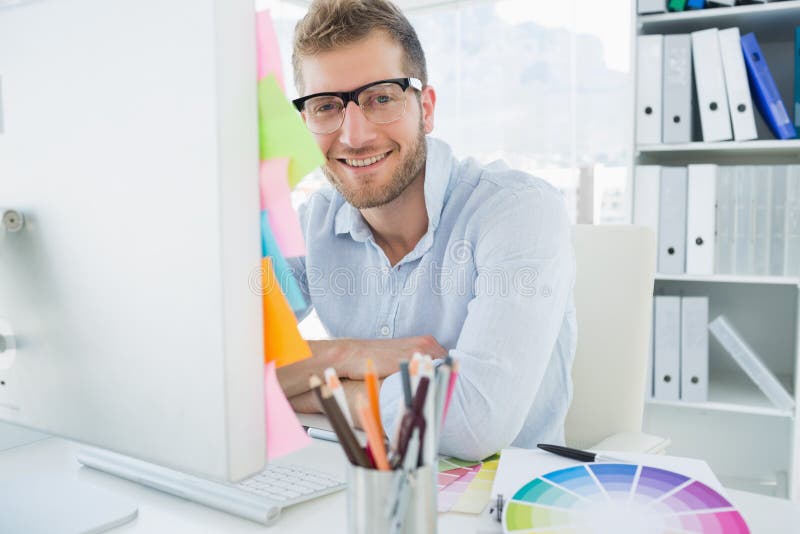 Portrait of a Smiling Young Man Using Computer Stock Photo - Image of ...