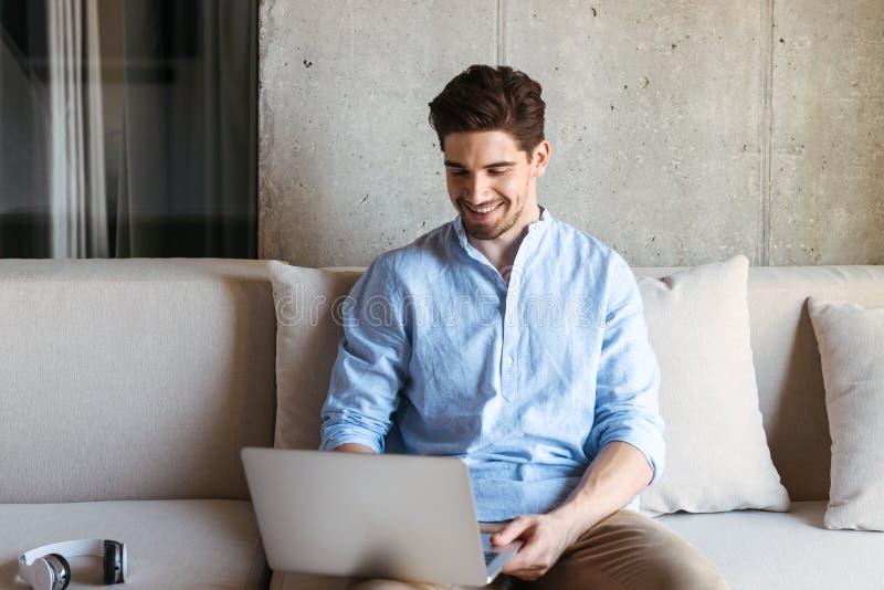 Portrait of a Smiling Young Man Using Laptop Computer Stock Photo ...