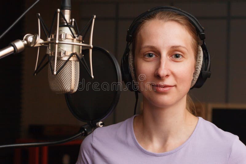 Portrait of a Smiling Young Woman in the Recording Studio with ...