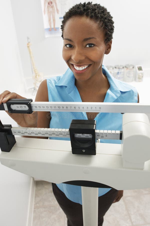 Portrait of Smiling Young Woman with Scales Stock Image - Image of ...