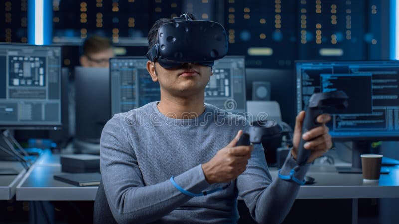Portrait of Software Delevoper Wearing Virtual Reality Headset Using Controllers To Develop and ...