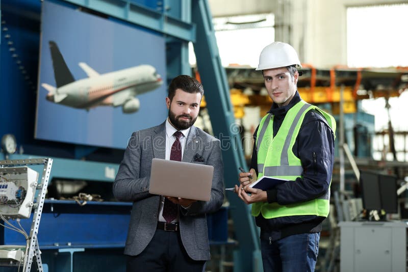 Portrait of a Solid Businessman with Laptop and Factory Engineer ...