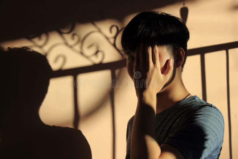 Portrait of Standing Man Covers Half of His Face with His Hands and ...