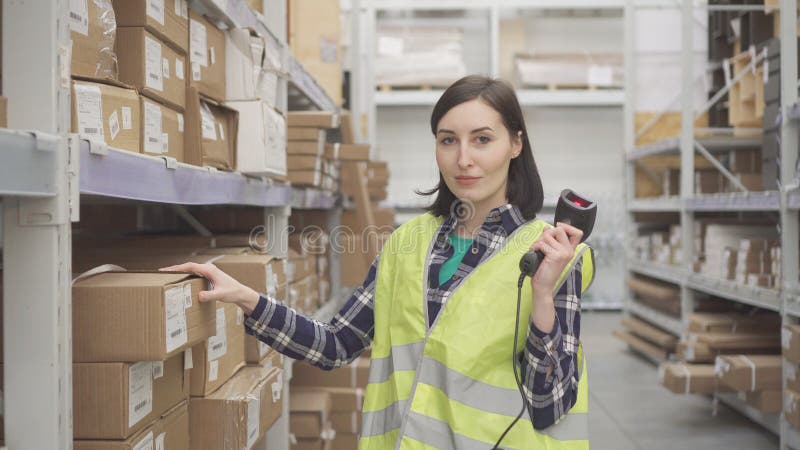 Portrait Store Worker Using Bar Code Scanner Scanning Labels on Boxes ...