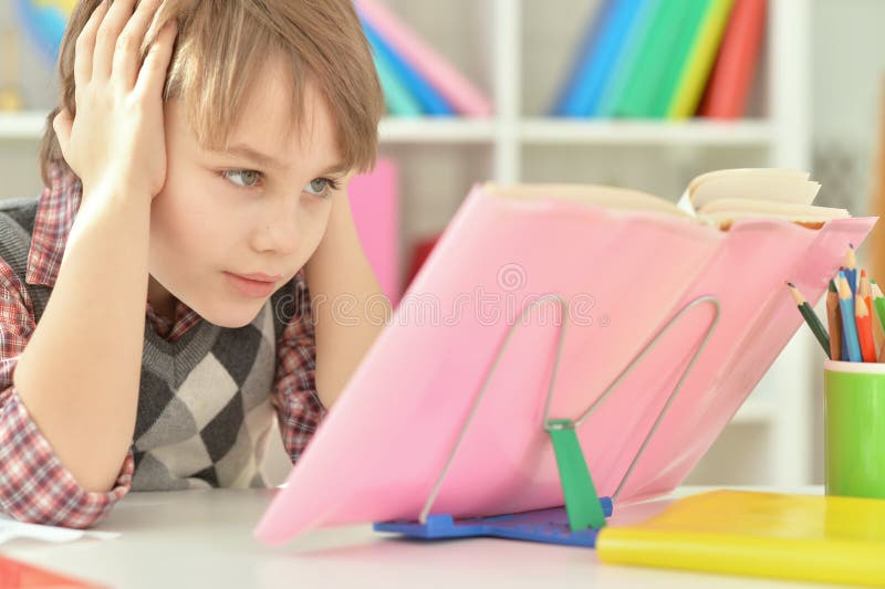 Boy doing homework stock image. Image of school, desk - 114191505