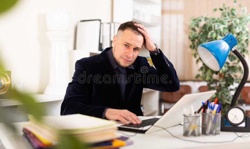 Stressed Young Man Working in Office Stock Photo - Image of mistakes ...