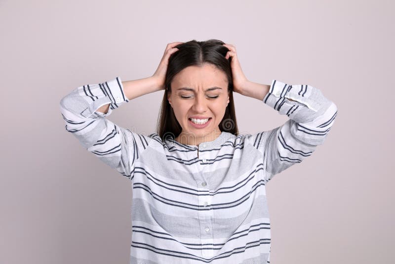 Portrait of Stressed Young Woman on Light Background Stock Photo ...