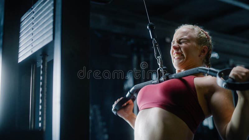 Portrait of Strong Woman Doing Weights Lifting Exercises Using Lat Pull ...