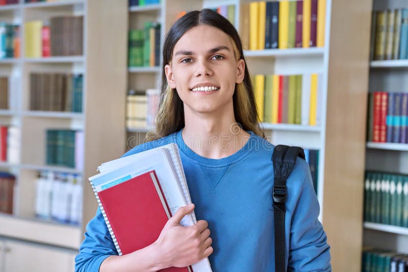 Portrait of a Student Guy with Textbooks Looking at Camera in College ...