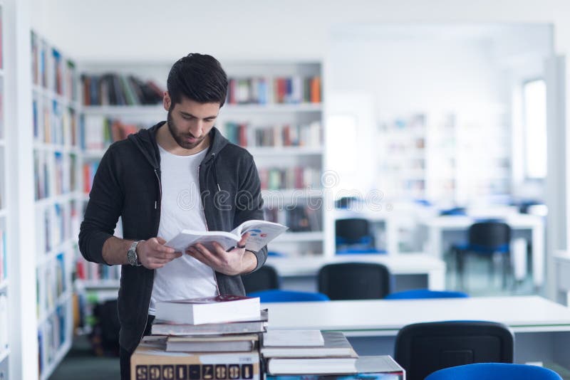 Portrait of Student while Reading Book in School Library Stock Image ...