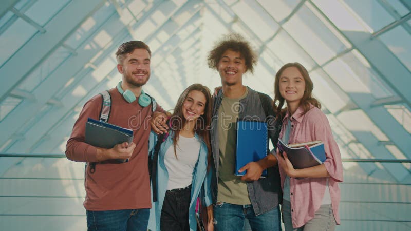 Portrait of Students Standing with Books and Notebooks, Posing Hugging ...
