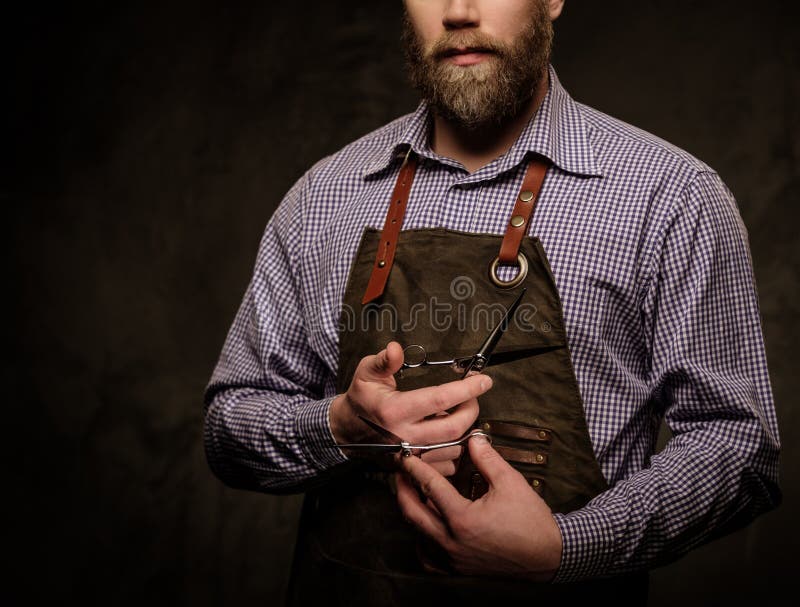 Portrait of Stylish Barber with Beard and Professional Tools on a Dark ...