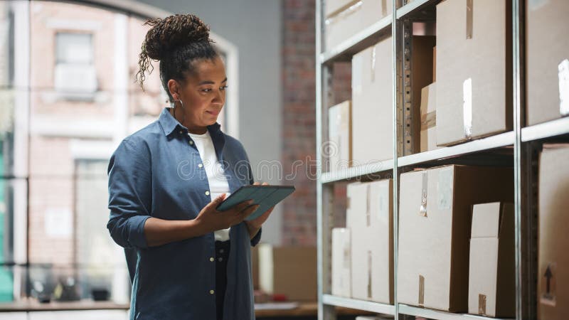 Portrait of a Successful Employee Checking Inventory, Writing in Tablet ...