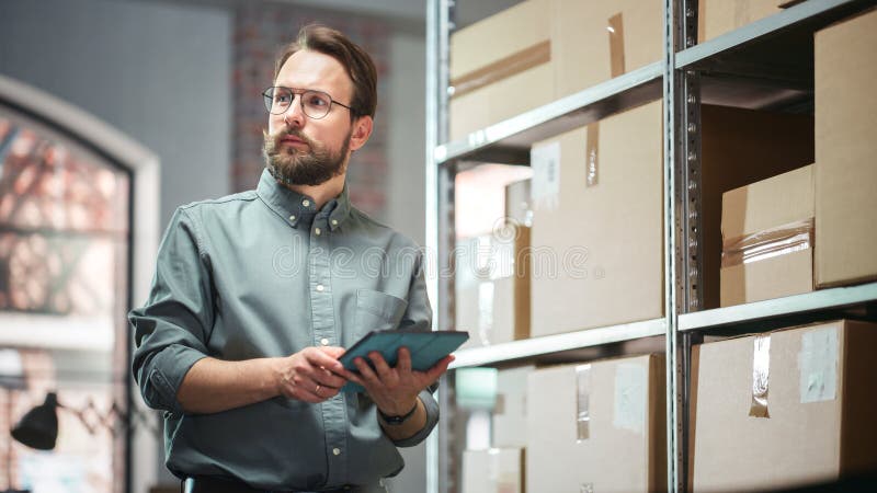 Portrait of a Successful Employee Checking Inventory, Writing in Tablet ...