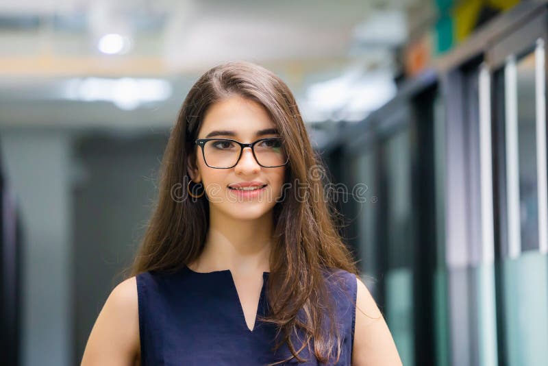 Portrait Of Successful Smiling Cheerful Business Woman In Office Stock