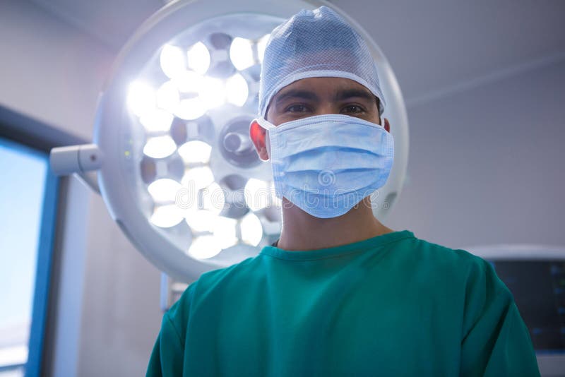 Portrait of Surgeon with Patient Lying on Bed in Operation Room Stock ...