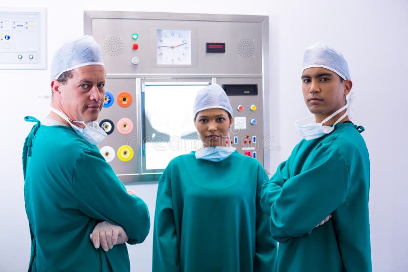 Portrait Of Happy Surgeons Standing In Corridor Stock Image - Image of ...