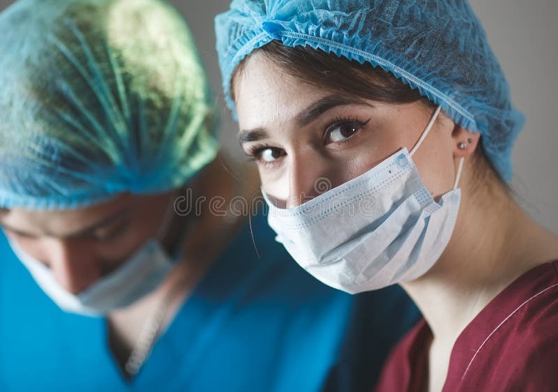 Portrait of Surgeons at Work, Operating in Uniform, Looking at Camera ...