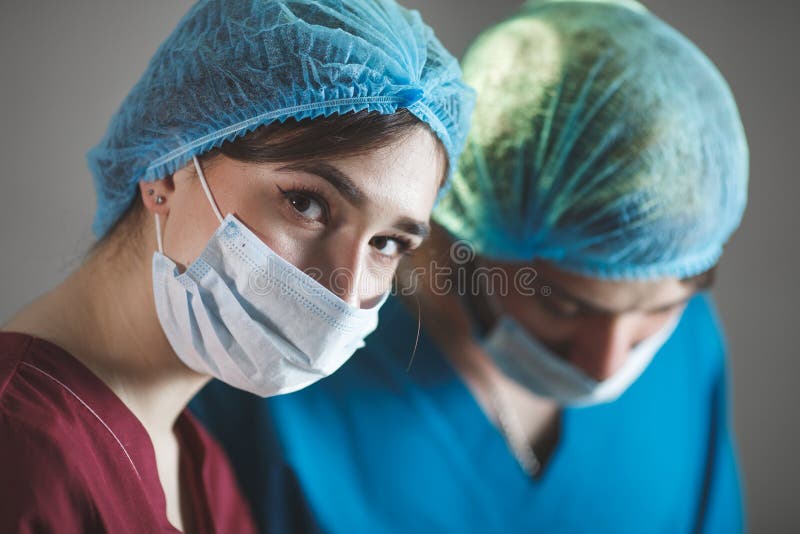 Portrait of Surgeons at Work, Operating in Uniform, Looking at Camera ...