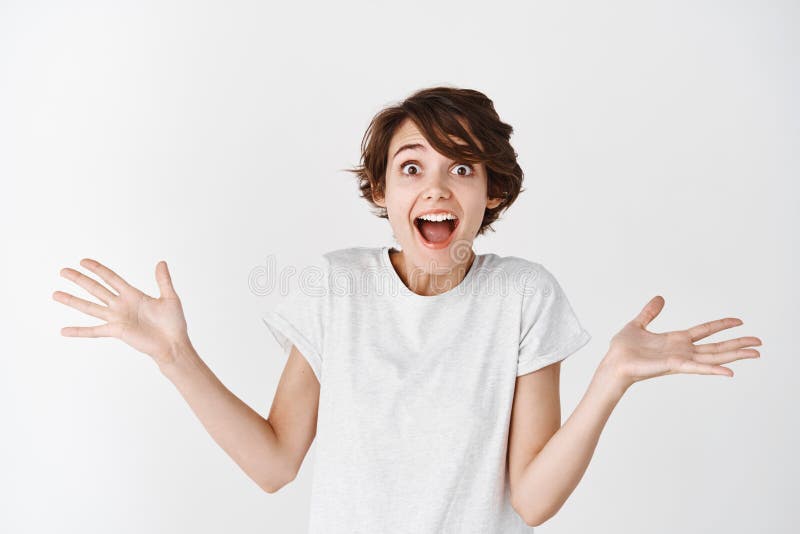Portrait Of Surprised Caucasian Woman Spread Hands Sideways And