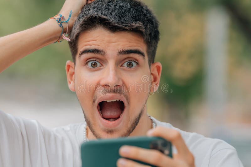 Surprised Excited Young Man Looking at Mobile Phone Stock Image - Image ...