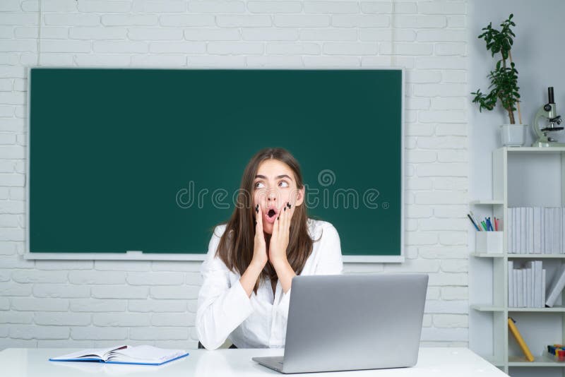 Portrait of a Surprised Female Student Studying in School Classroom ...