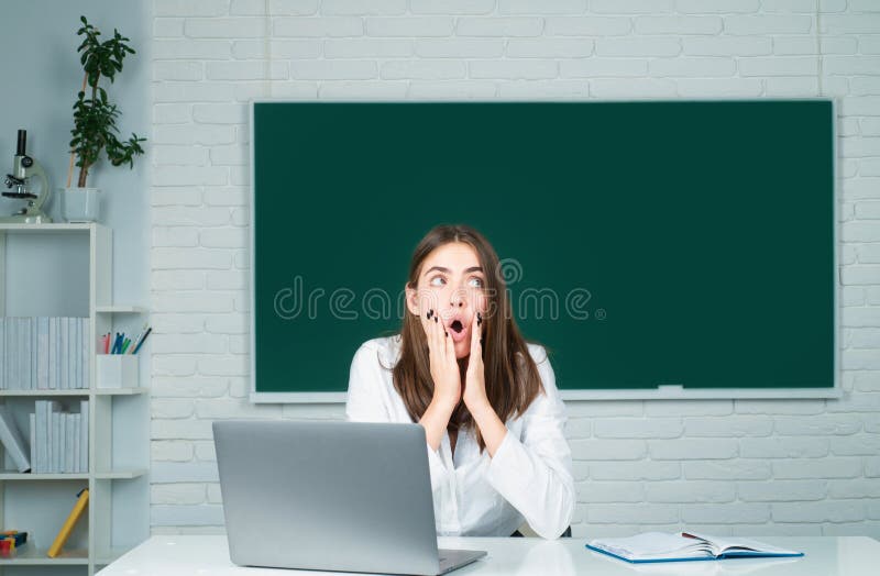 Portrait of a Surprised Female Student Studying in School Classroom ...