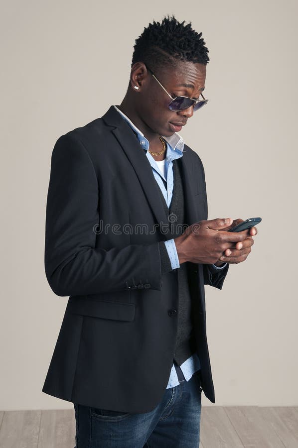 Portrait of Surprised Young African Guy Looking at Cell Phone Stock ...