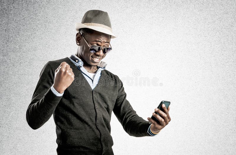 Portrait of Surprised Young African Guy Looking at Cell Phone Stock ...