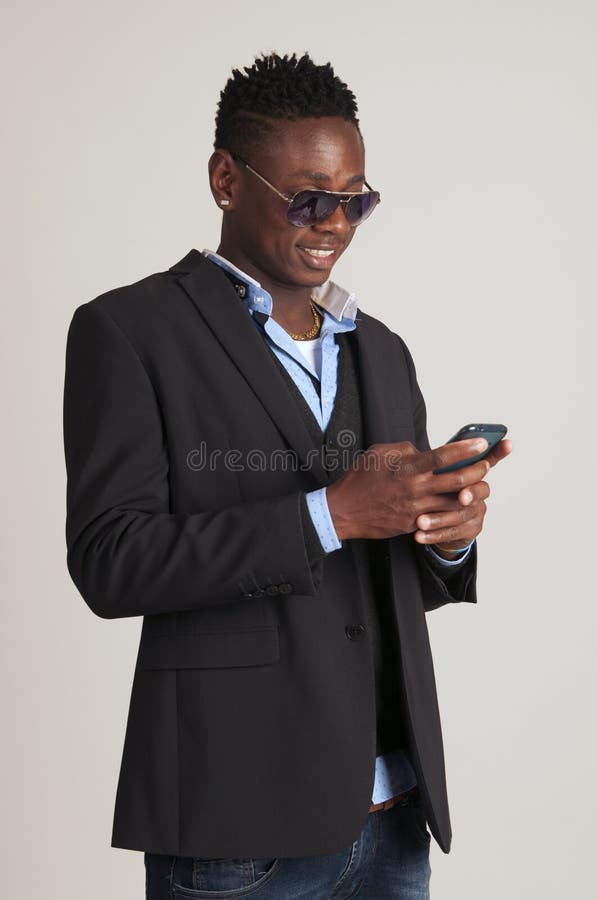 Portrait of Surprised Young African Guy Looking at Cell Phone Stock ...