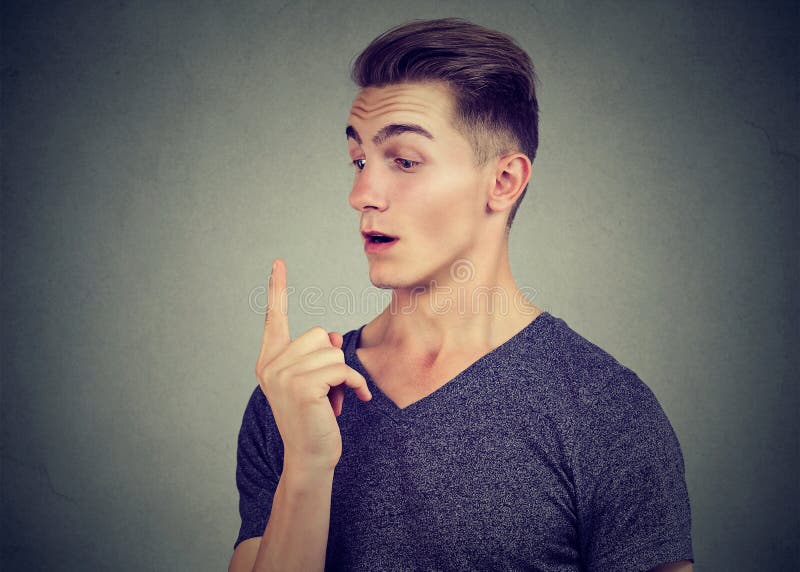 Portrait of a Surprised Young Man Looking at His Index Finger Stock ...