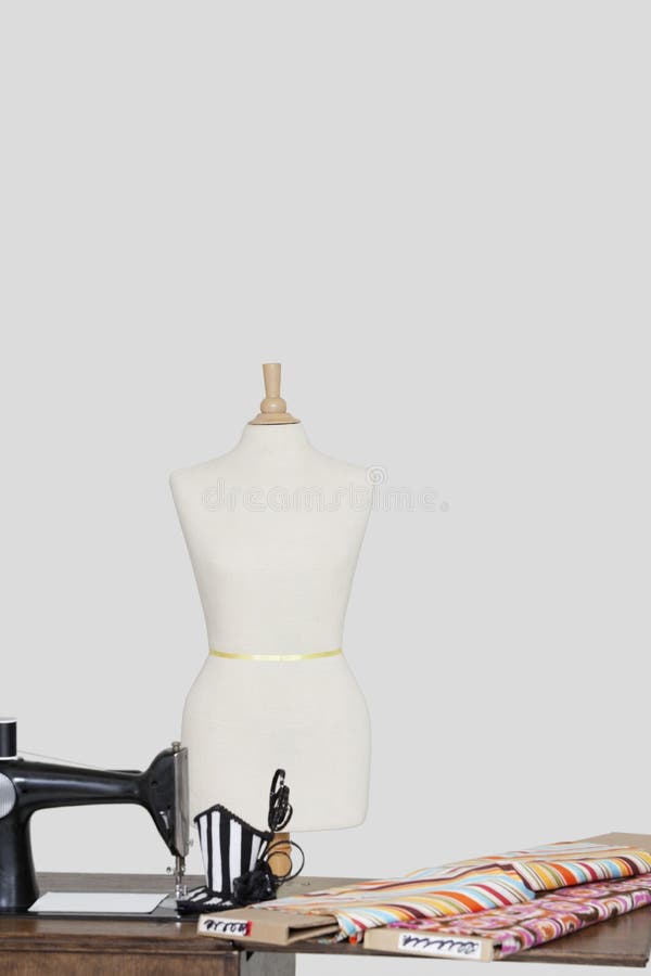 Tailor`s Dummy with Hat and Cloth Pattern on Sewing Machine Over ...